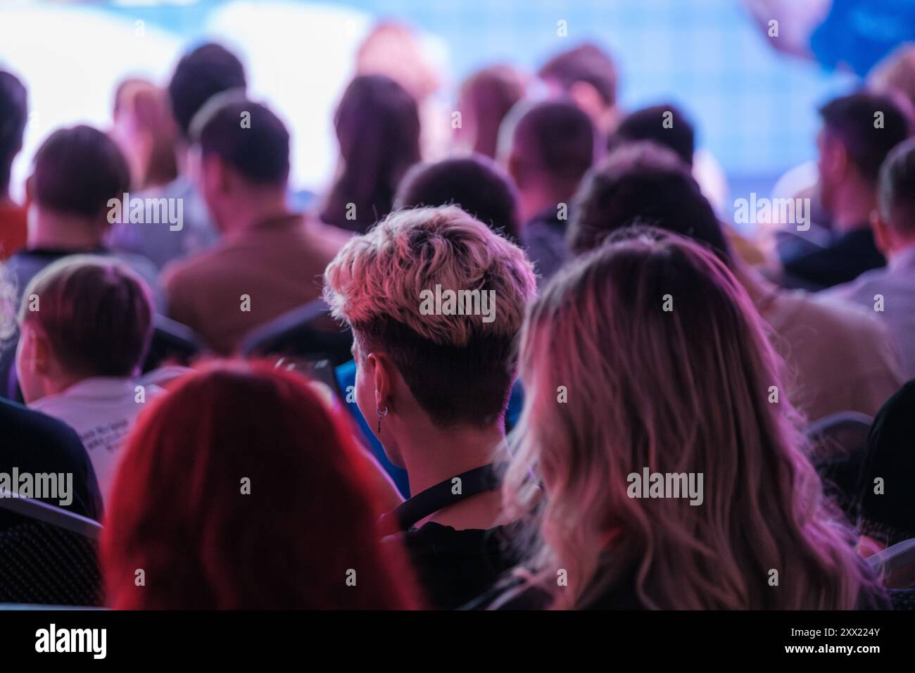 Large group of people attending conference focusing on stage ...