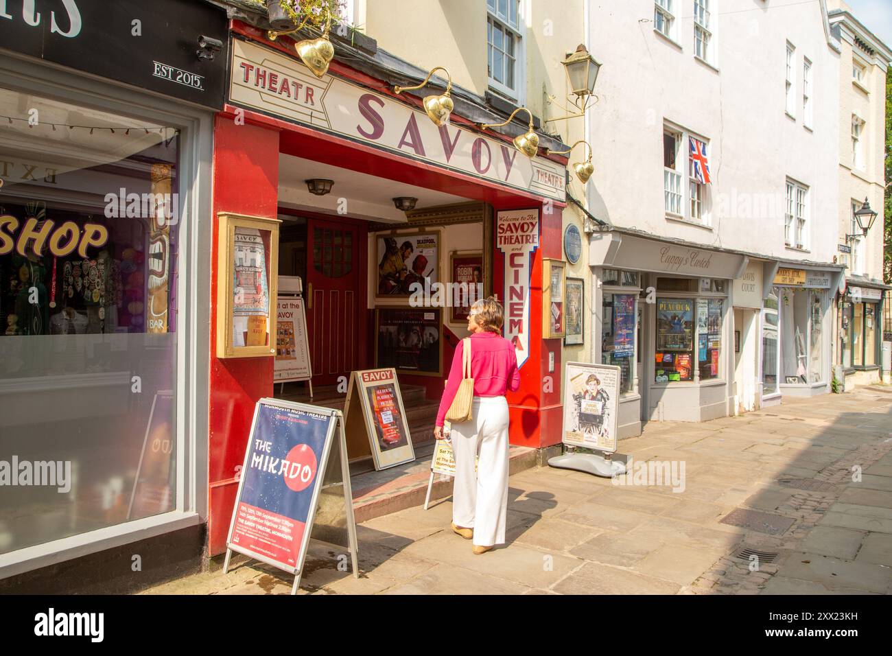 Woman about to enter the Savoy cinema and theatre in church Street ...