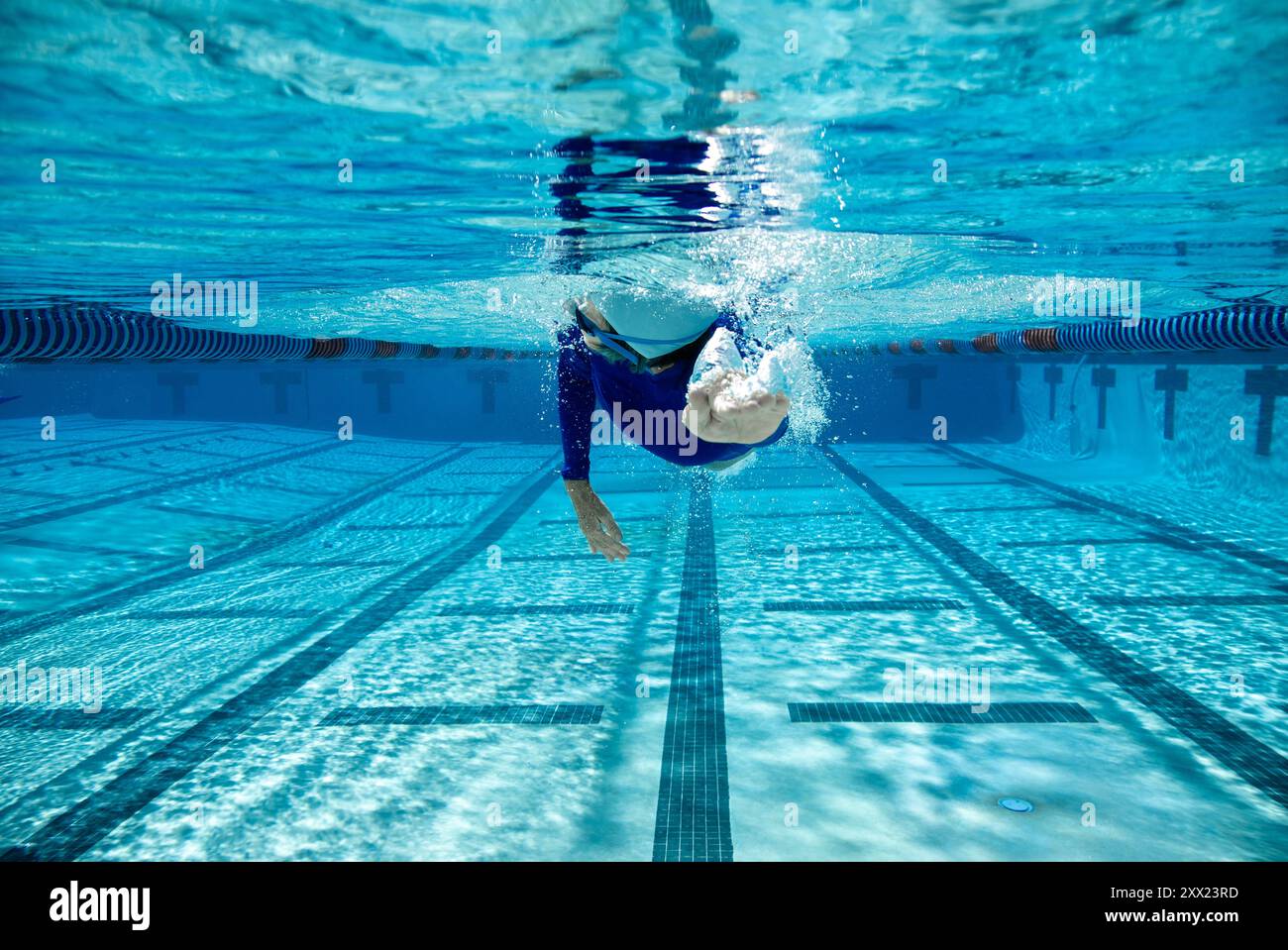 Underwater shot of a senior woman swimming front crawl in a swimming ...
