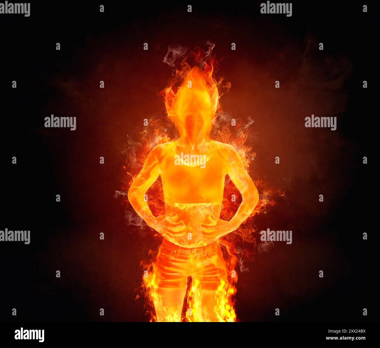 Conceptual woman on fire with her hands on her stomach Stock Photo - Alamy