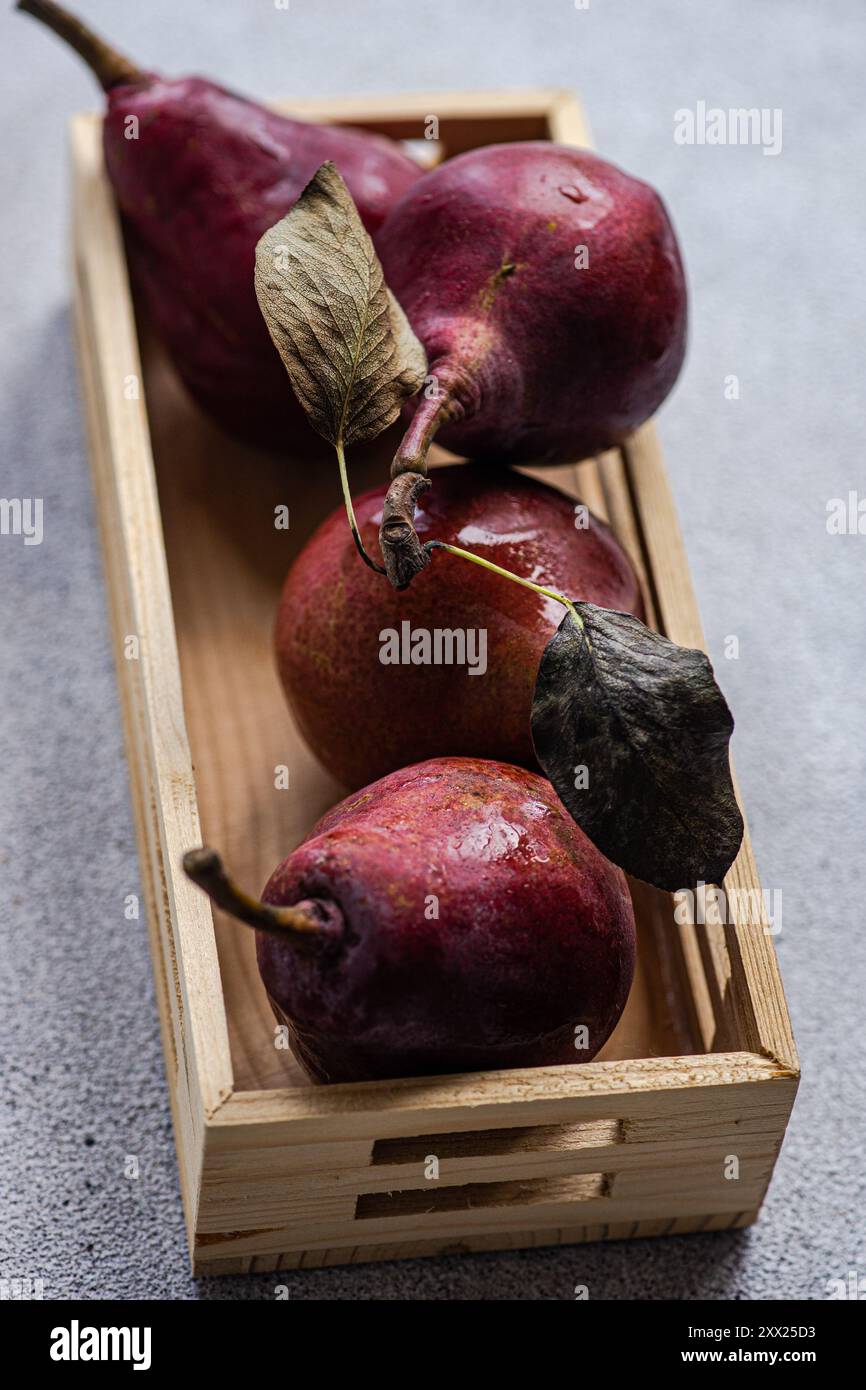 Overhead view of four Red Bartlett pears in a wooden box Stock Photo ...