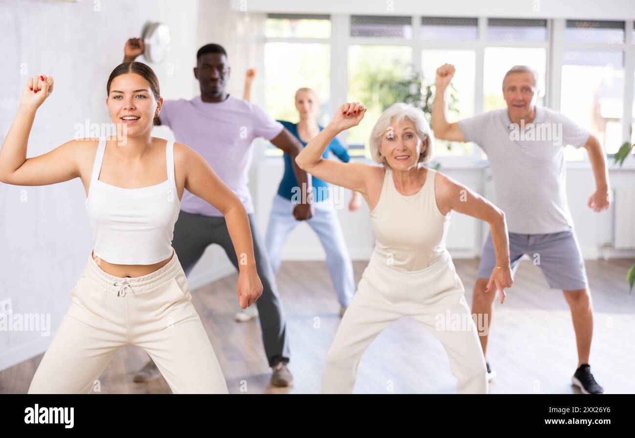 Men and women of different ages practicing Hip-hop dance in training ...