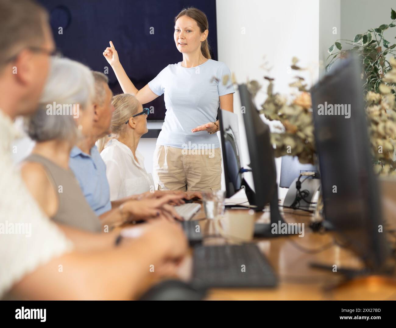 Female instructor leading computer session for older adults Stock Photo ...