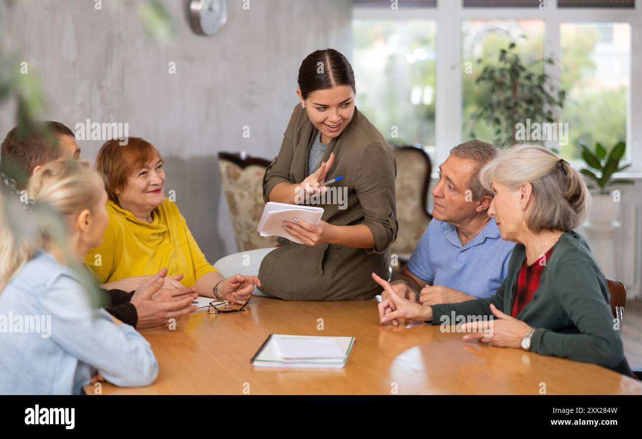 Young female professor giving lecture to elderly students Stock Photo ...