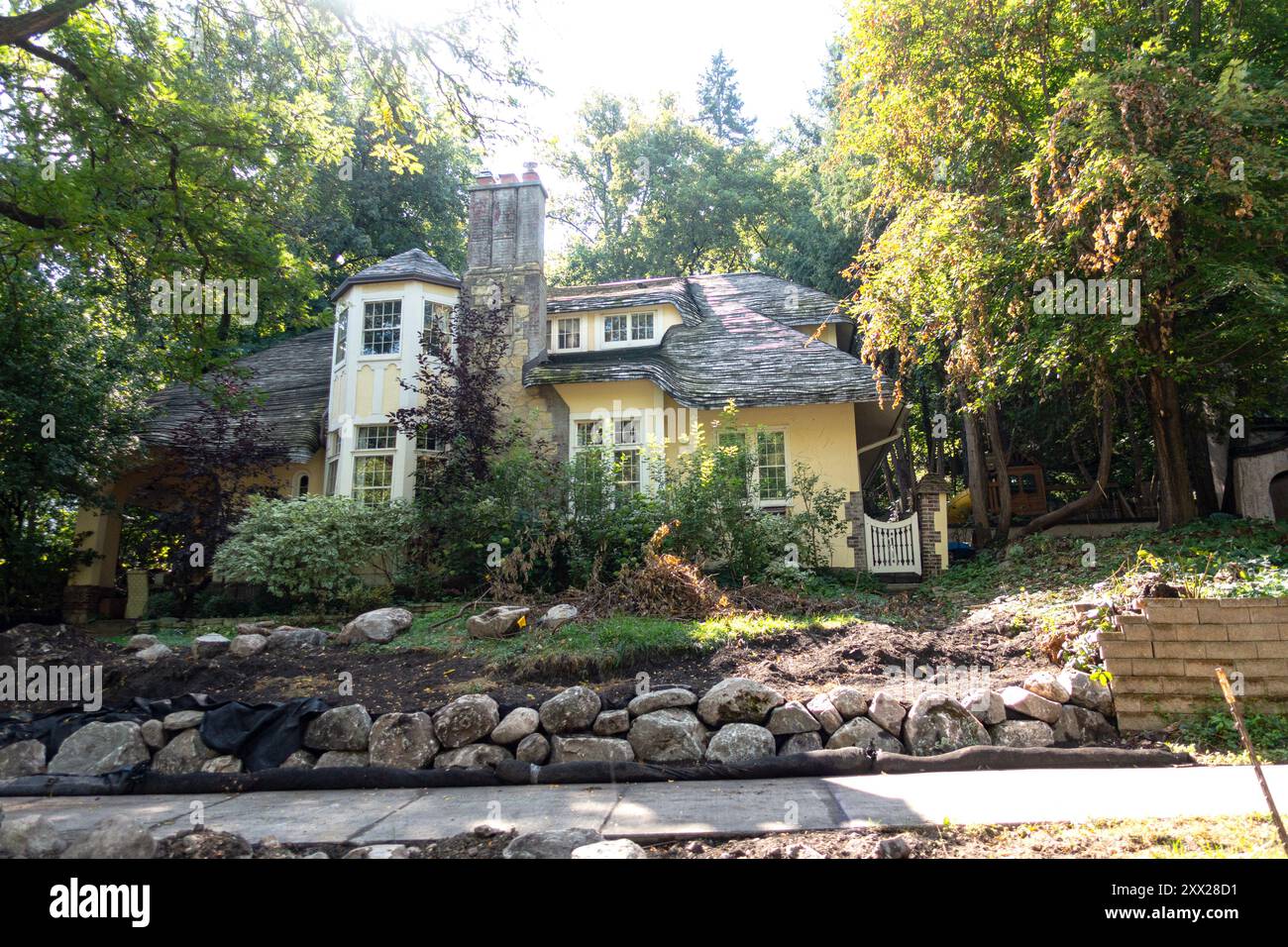 Architecturally designed upscale home with fieldstone embankment ...