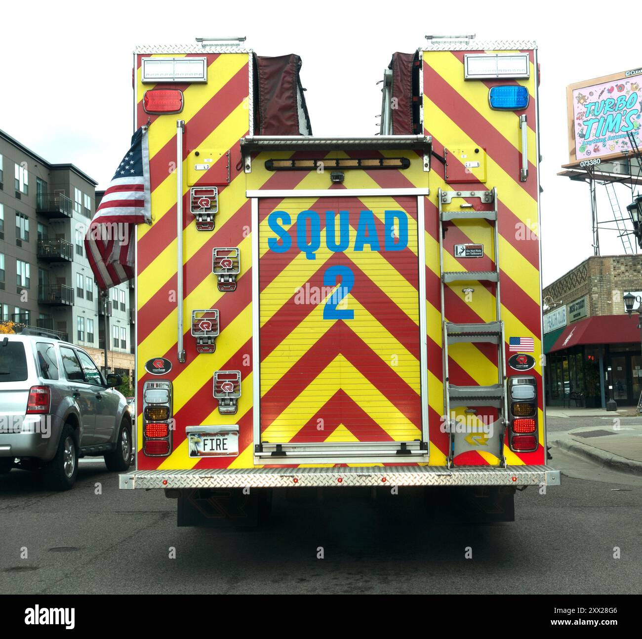 Rear of an emergency vehicle with yellow and red warning stripes. St ...