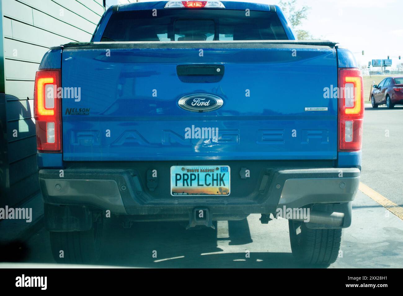 Bright blue Ford pickup truck with designer license plate PRPL CHK ...