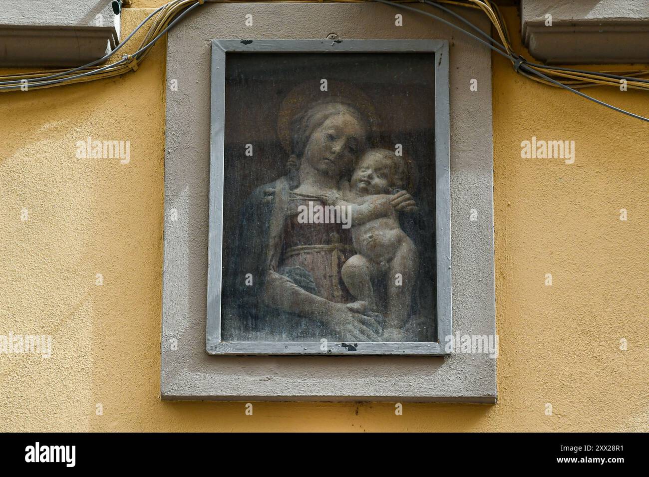 Detail of a tabernacle with a painted stucco bas-relief of the Madonna ...