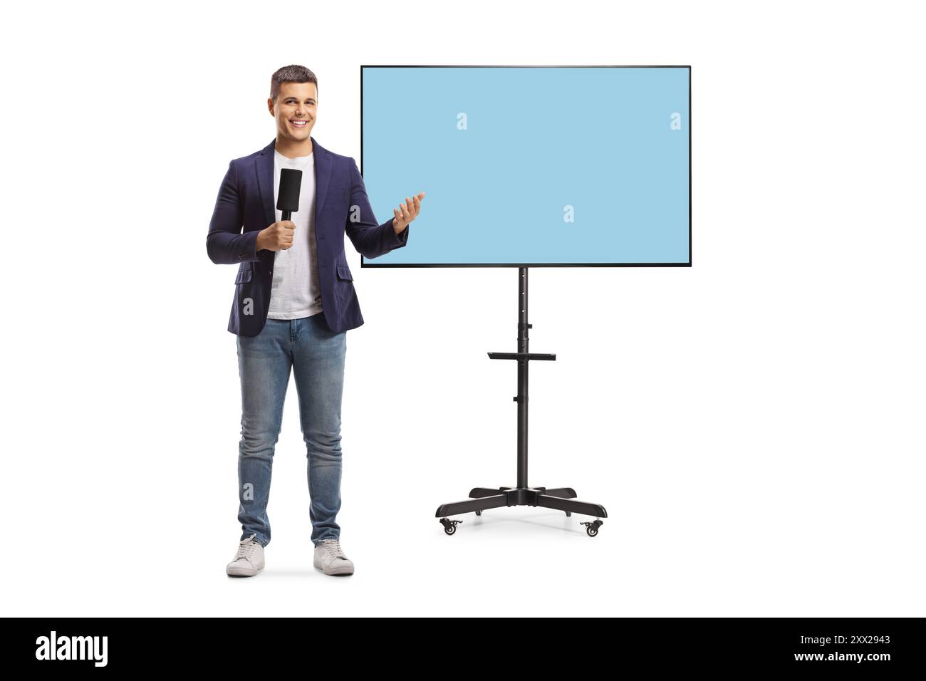 Full length portrait of male reporter with a microphone in front of a ...