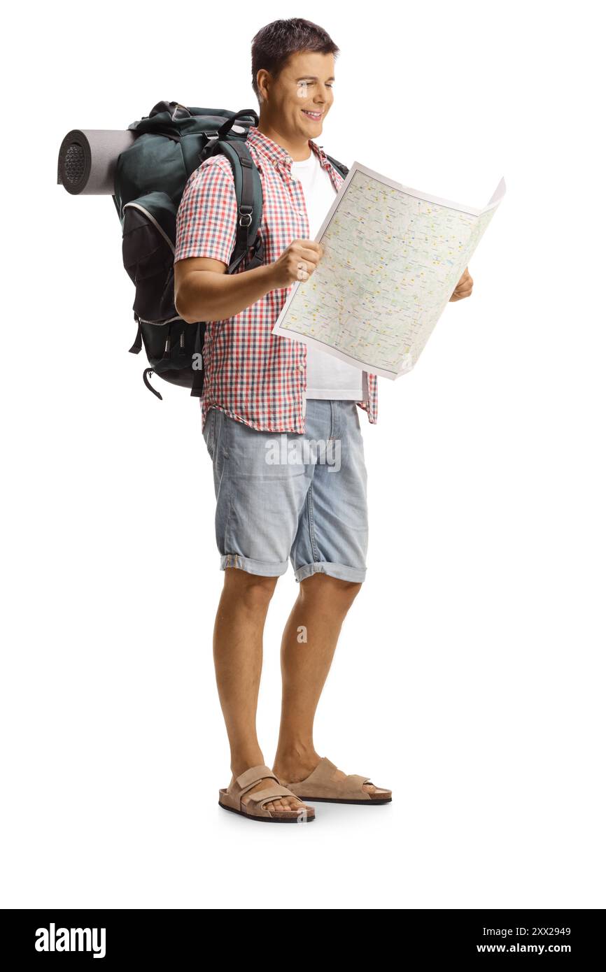 Full length shot of a male tourist with a backpack reading a map ...