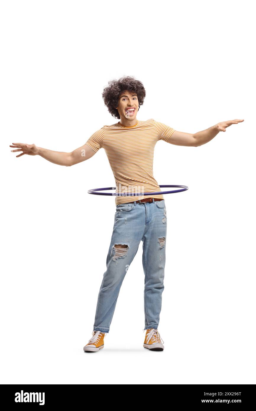 Happy young man spinning a hula hoop isolated on white background Stock ...