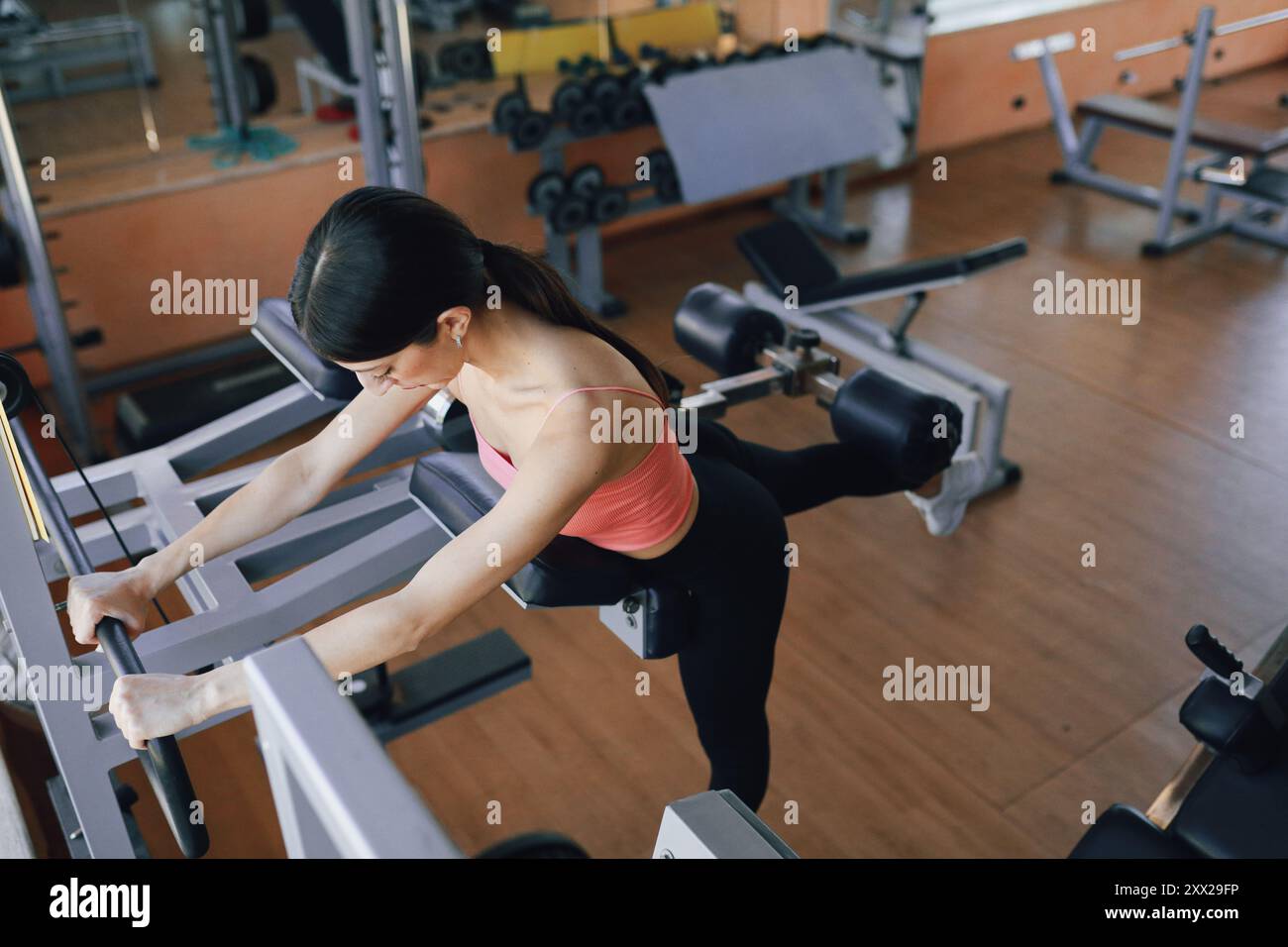 Woman Extending The Legs To Lift Weight Stock Photo - Alamy