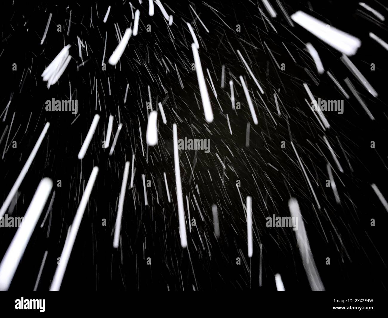 Snow falling at night showing long streaks of white light Stock Photo ...