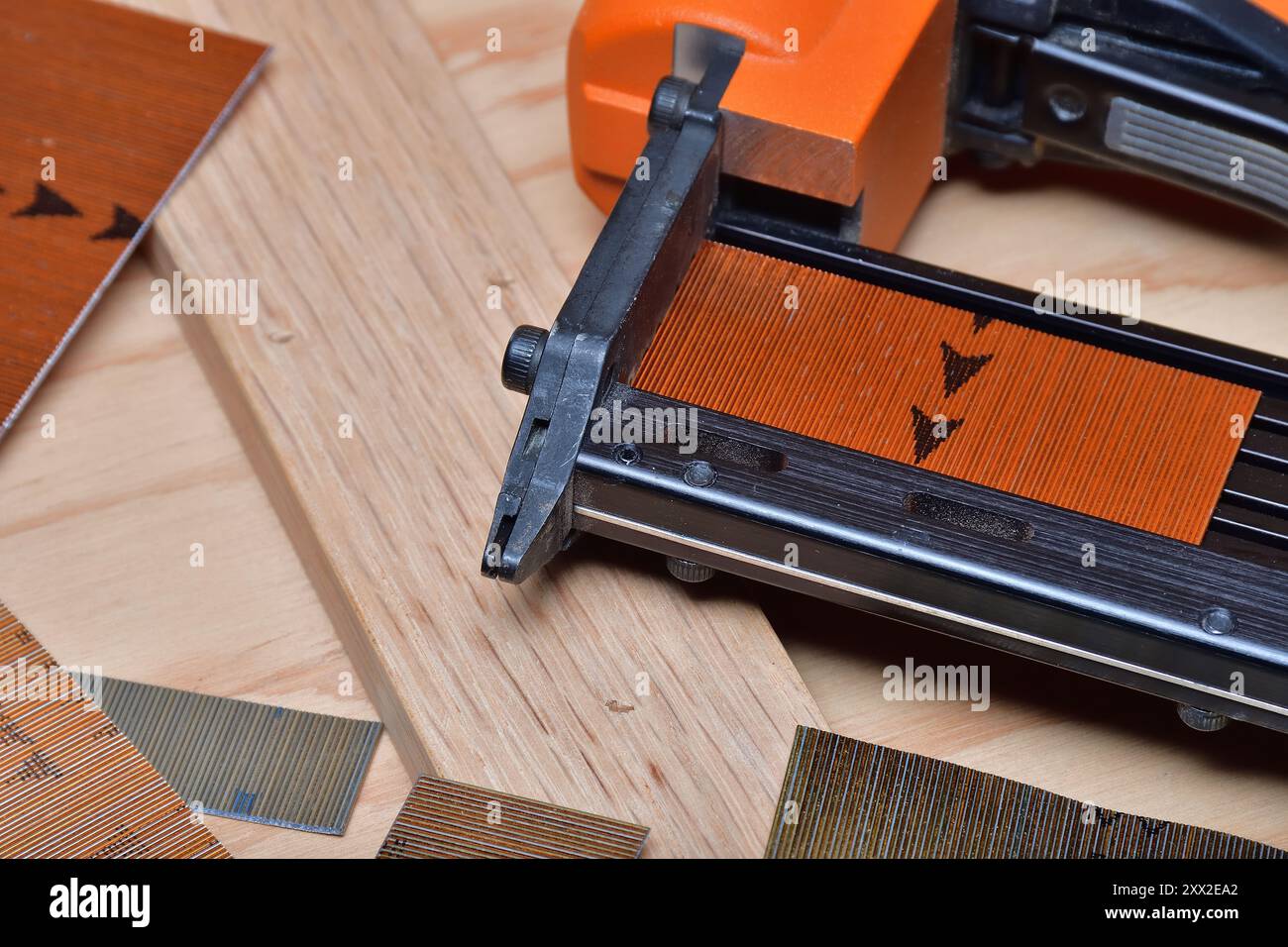 Reloading brad nail into Pneumatic gun nailer for woodworking. Air ...