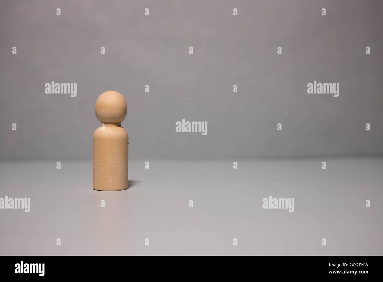 Wooden human figure with question marks. The concept of question or ...