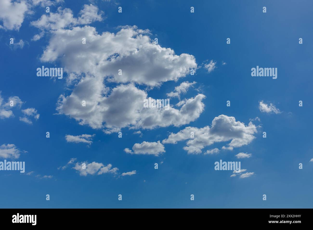 The sunlight subtly illuminates the clouds floating through a clear ...