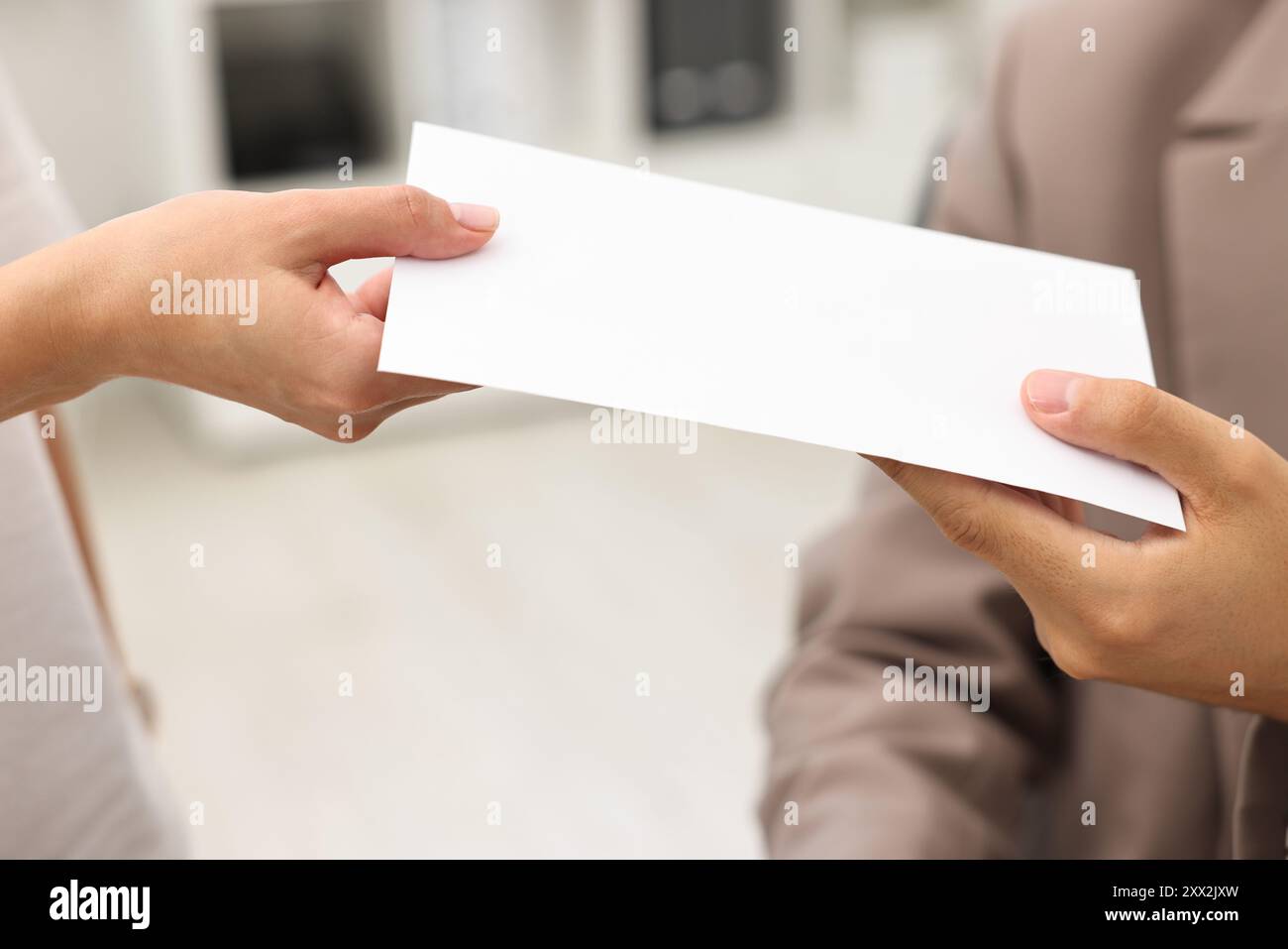 Employee receiving envelope with salary from boss in office, closeup ...