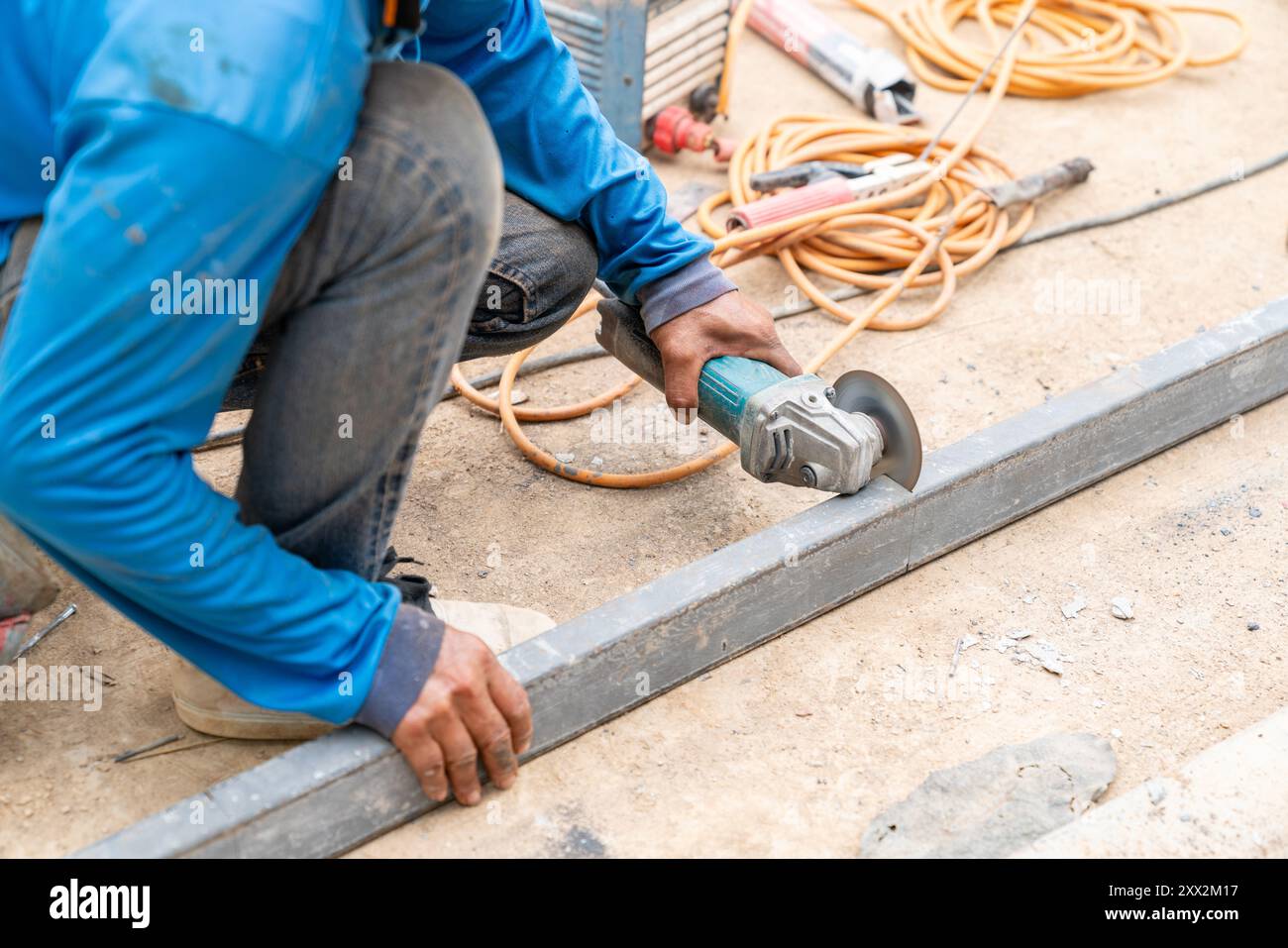 Worker cut a steel square pipe with grinding machine in plant Stock ...