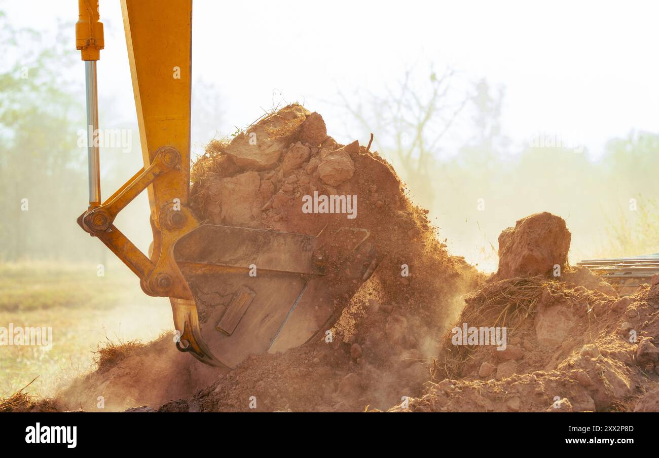 Closeup bucket of backhoe digging the soil at construction site ...