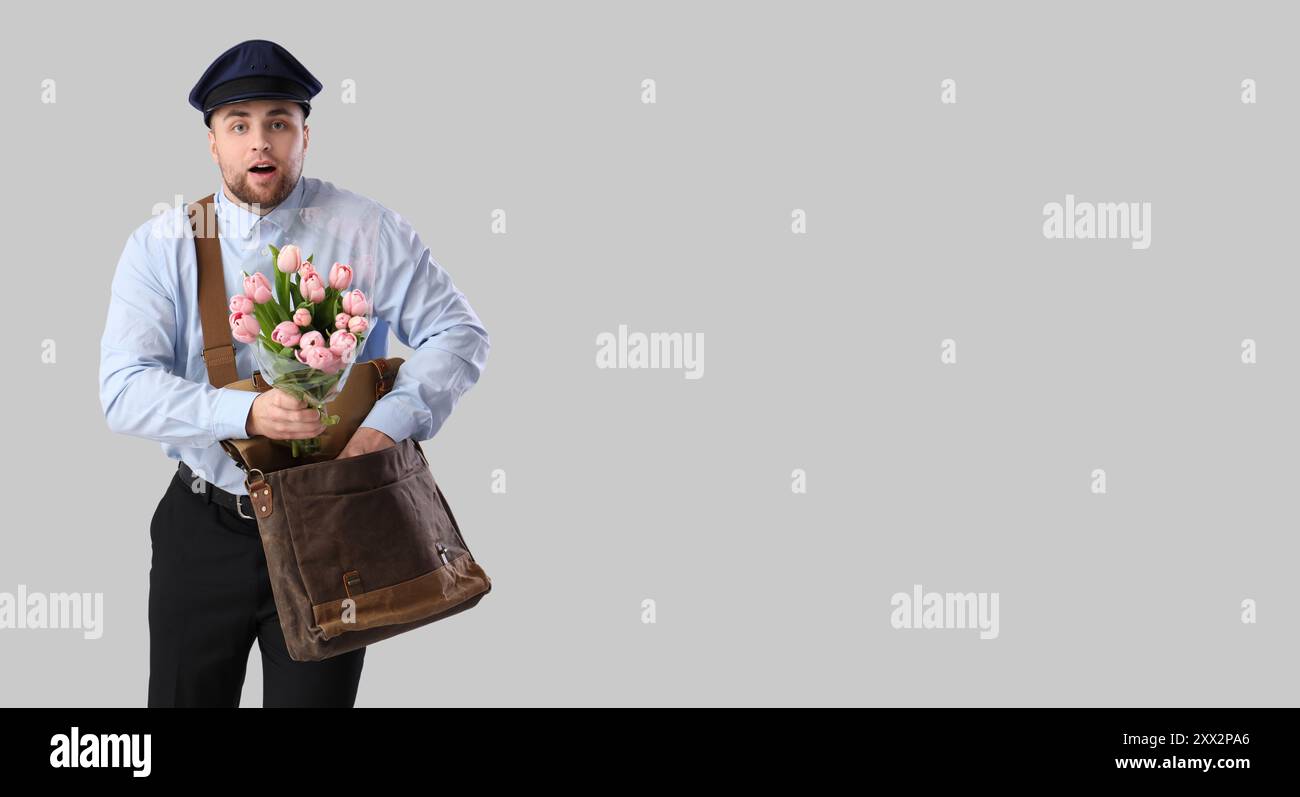 Surprised postman with tulips and bag on light background with space ...
