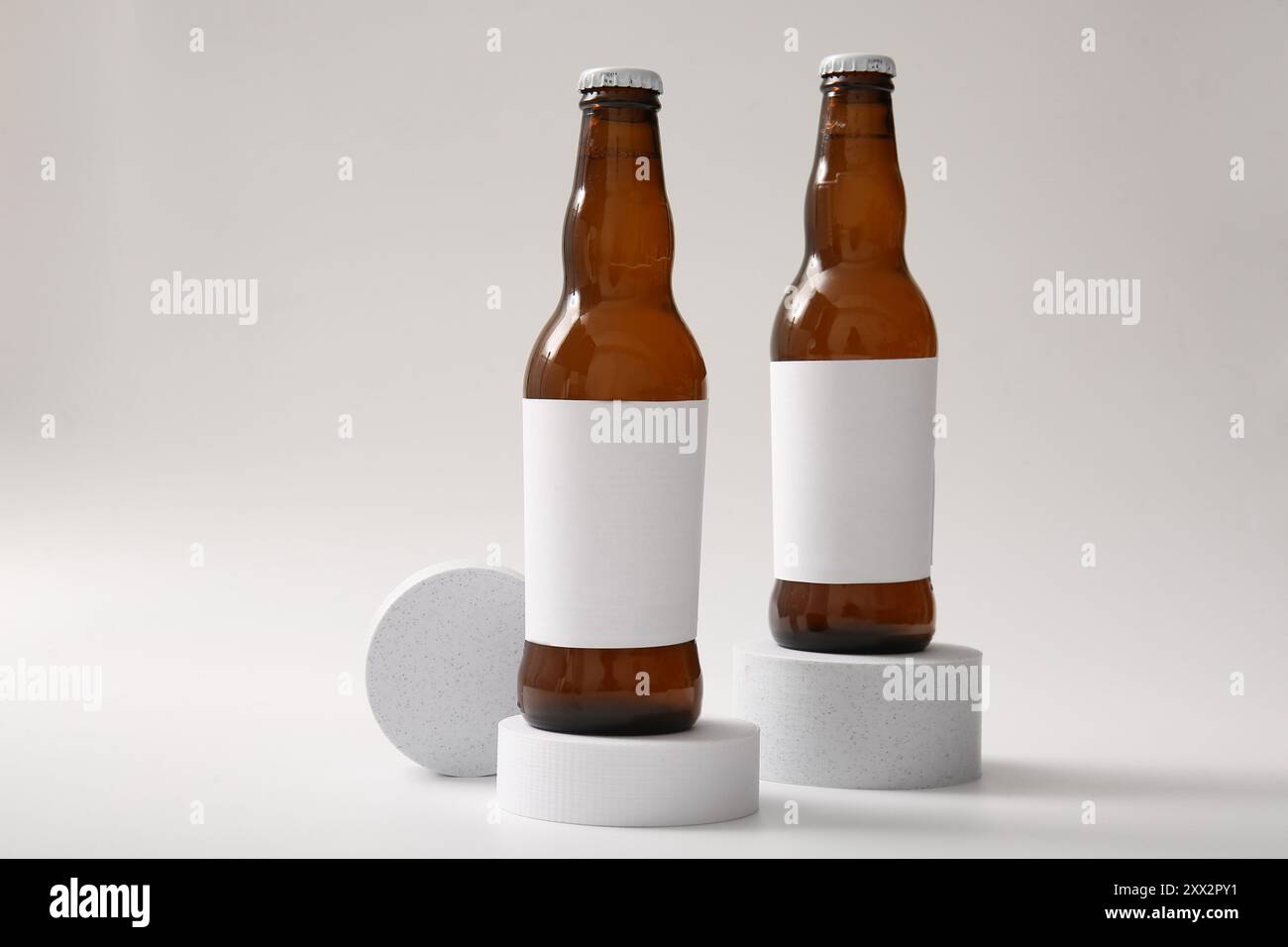 Decorative podiums with bottles of cold beer on grey background Stock ...