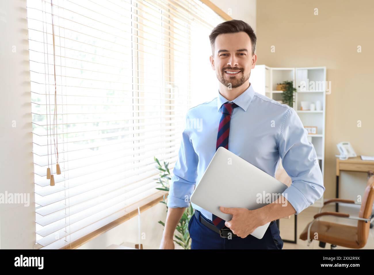 Male accountant with laptop in office Stock Photo - Alamy
