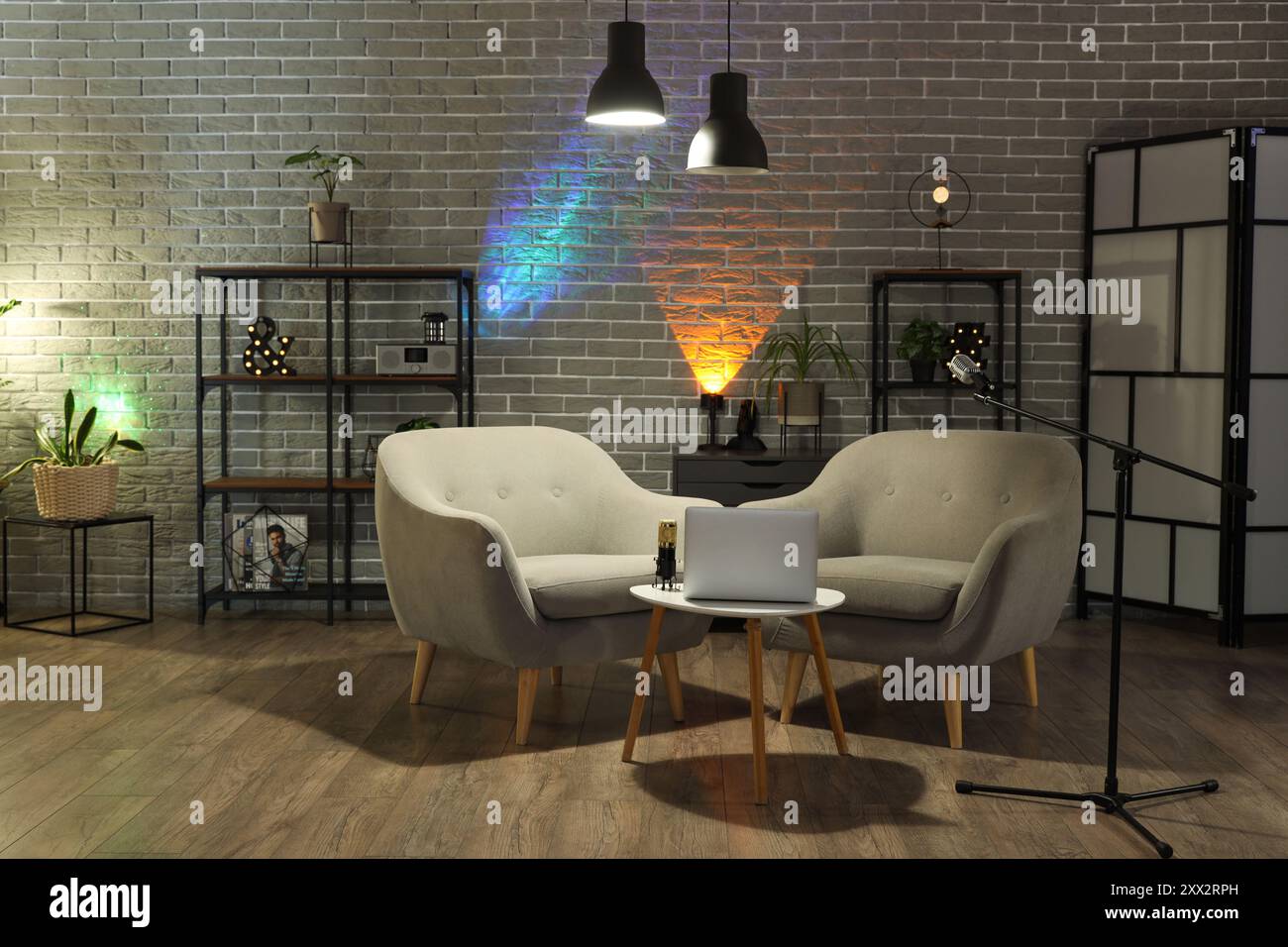 Interior of dark studio with podcaster's workplace, shelf units and ...