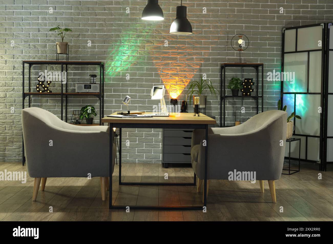 Interior of dark studio with podcaster's workplace, shelf units and ...