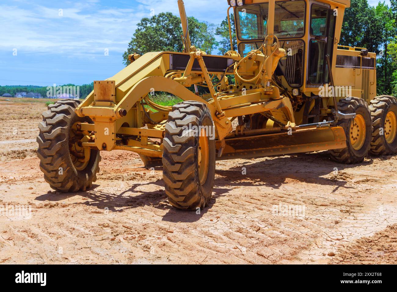Heavy an earthmoving construction grader tractor with working at ...