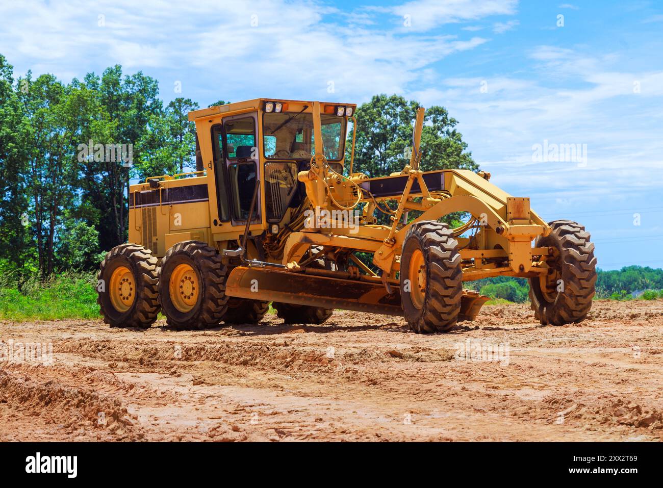 An earthmoving construction grader tractor at construction site Stock ...