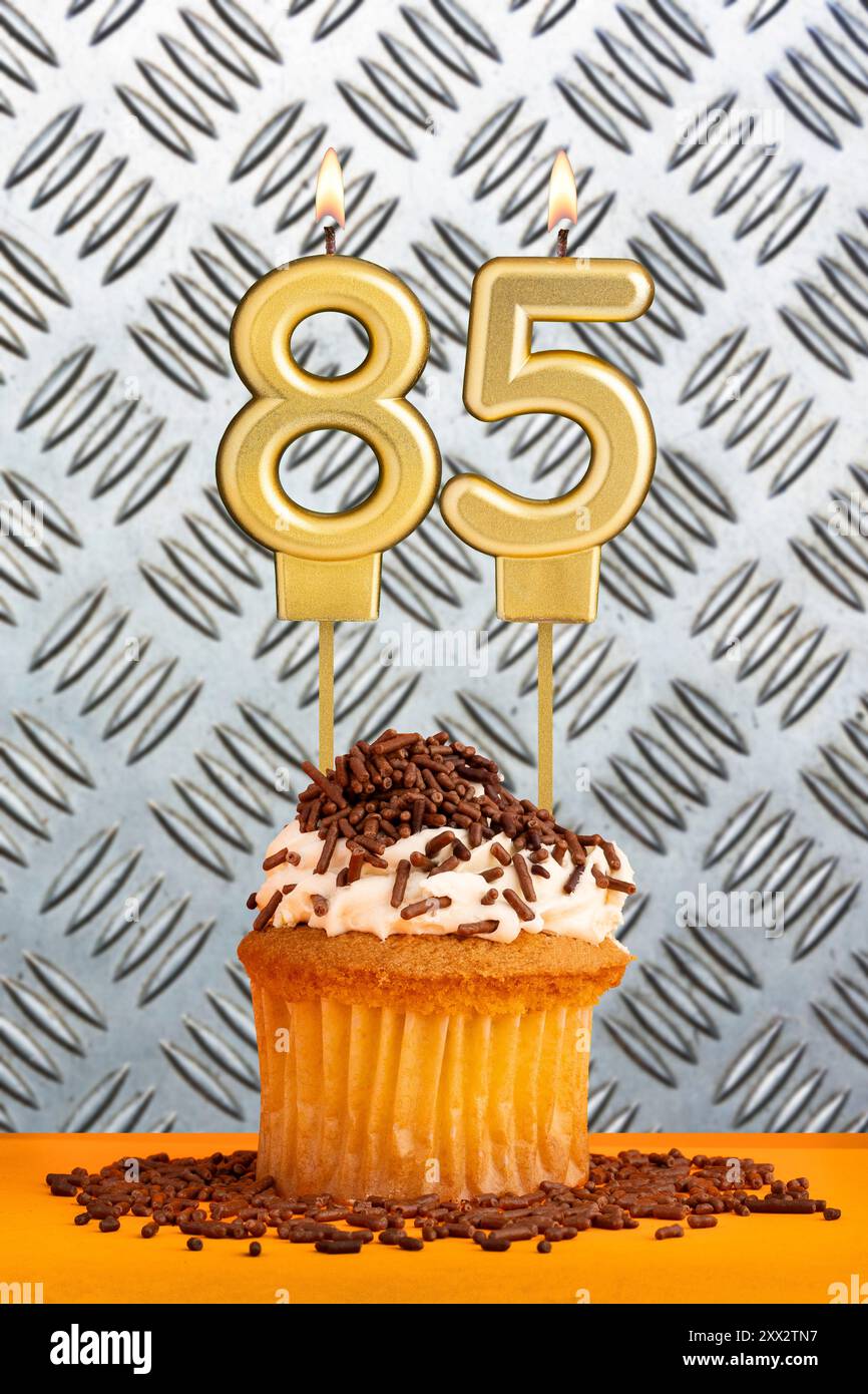 Chocolate cupcake with candle number 85 - Birthday on industrial ...
