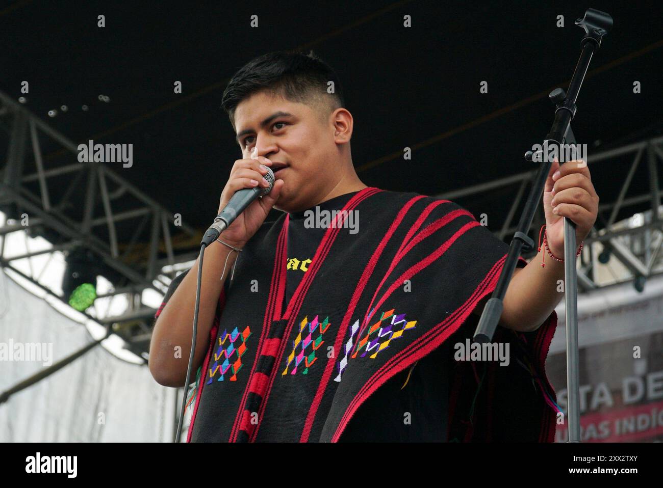 Mexican-Triqui artist Carlos CGH, wearing a black and red “gabán,” a ...