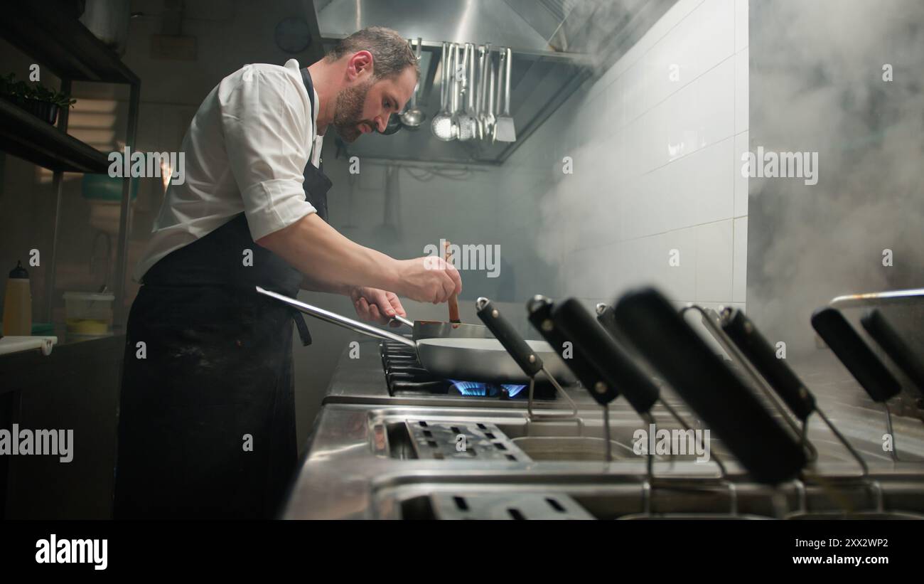 Chef Turning On The Stove Under The Pan Stock Photo - Alamy