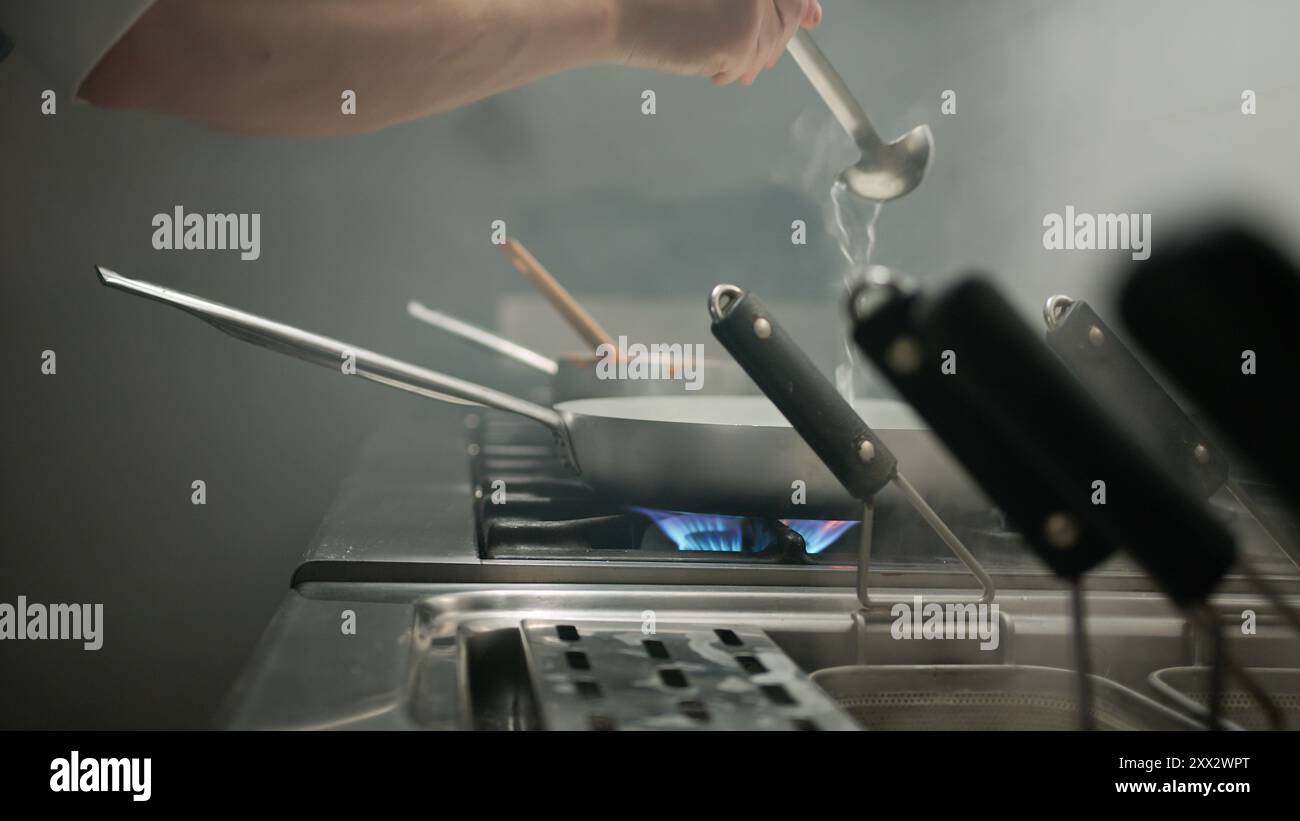 Adding Water To The Pan To Complete The Cooking Stock Photo - Alamy