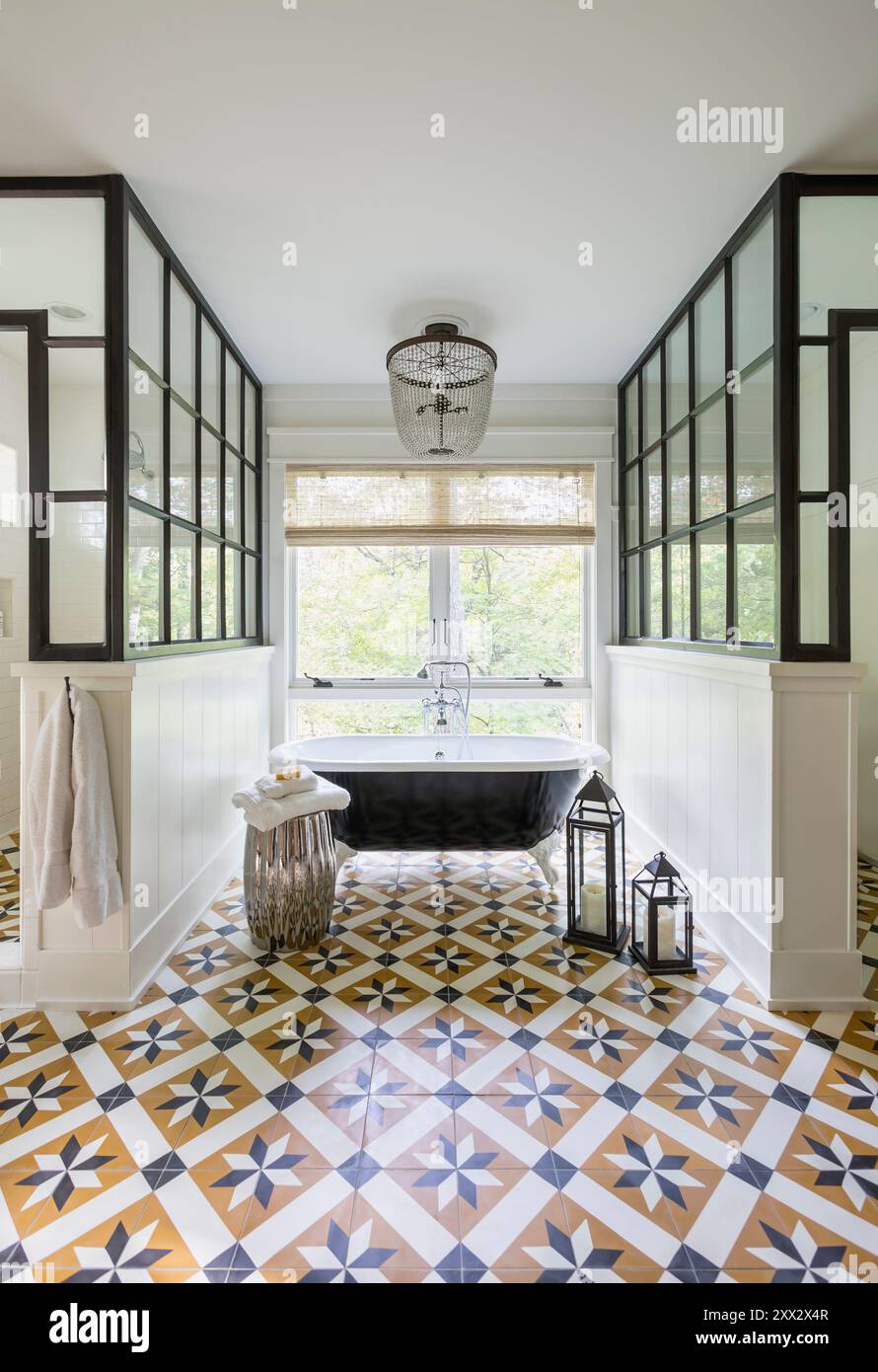 Stylish bathroom with black and white claw foot tub and metal framed ...