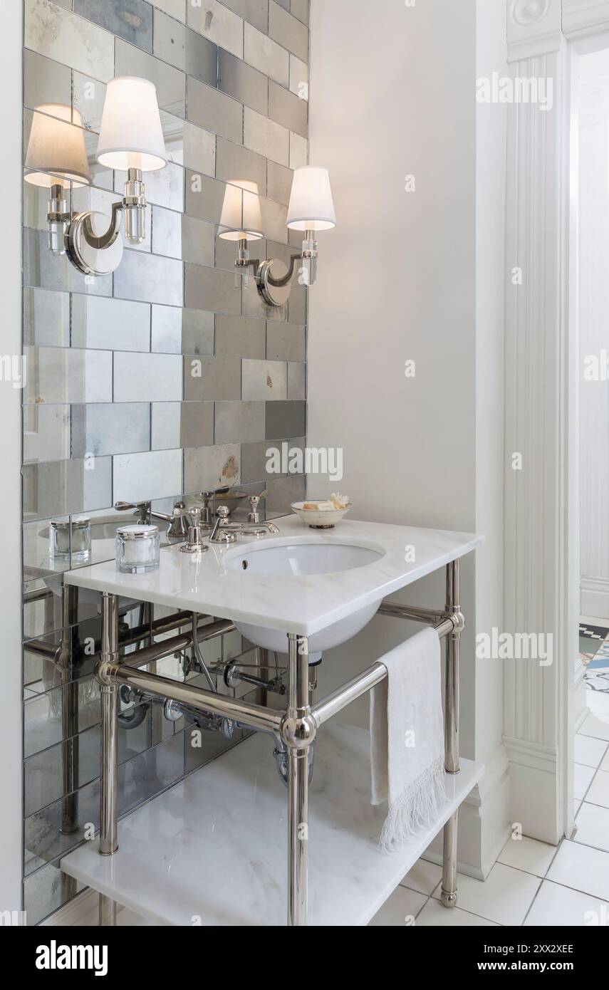Waterworks vanity washstand in front of wall of Ann Sacks mirror tile ...