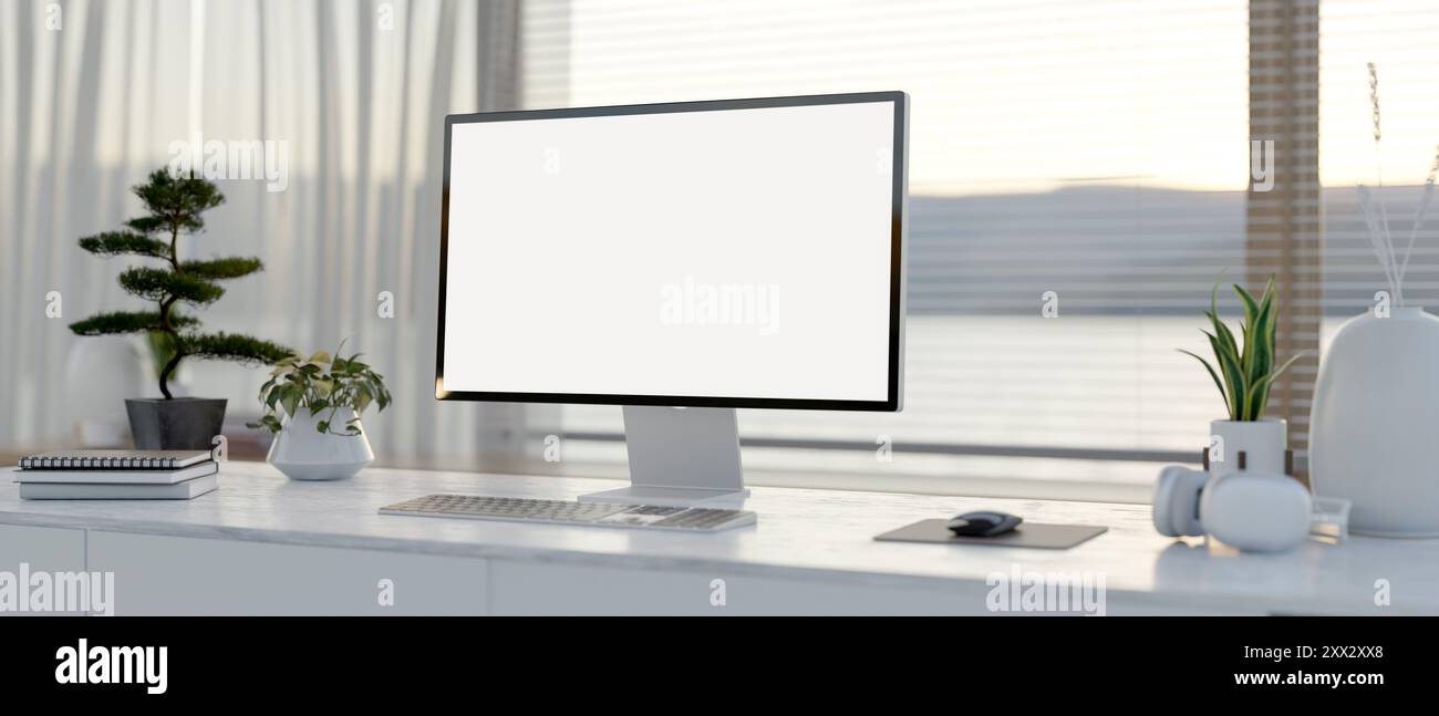 A computer desk featuring a computer with a white-screen mockup, books ...