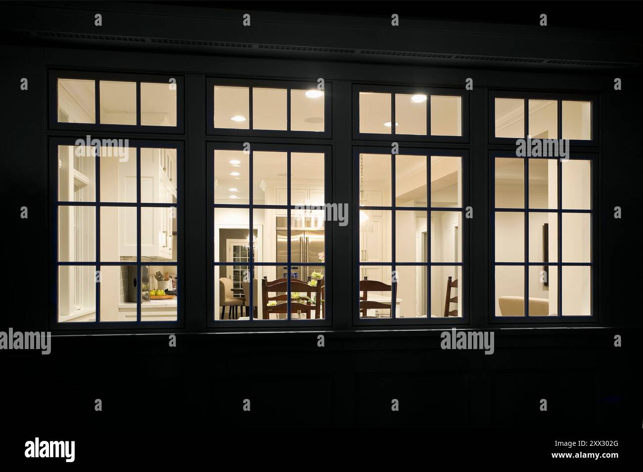 Looking into kitchen windows at night with lights on Stock Photo - Alamy