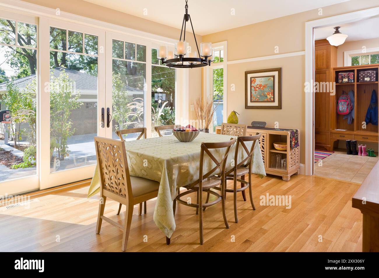 Sun streams into dining room through sliding glass doors with view into ...