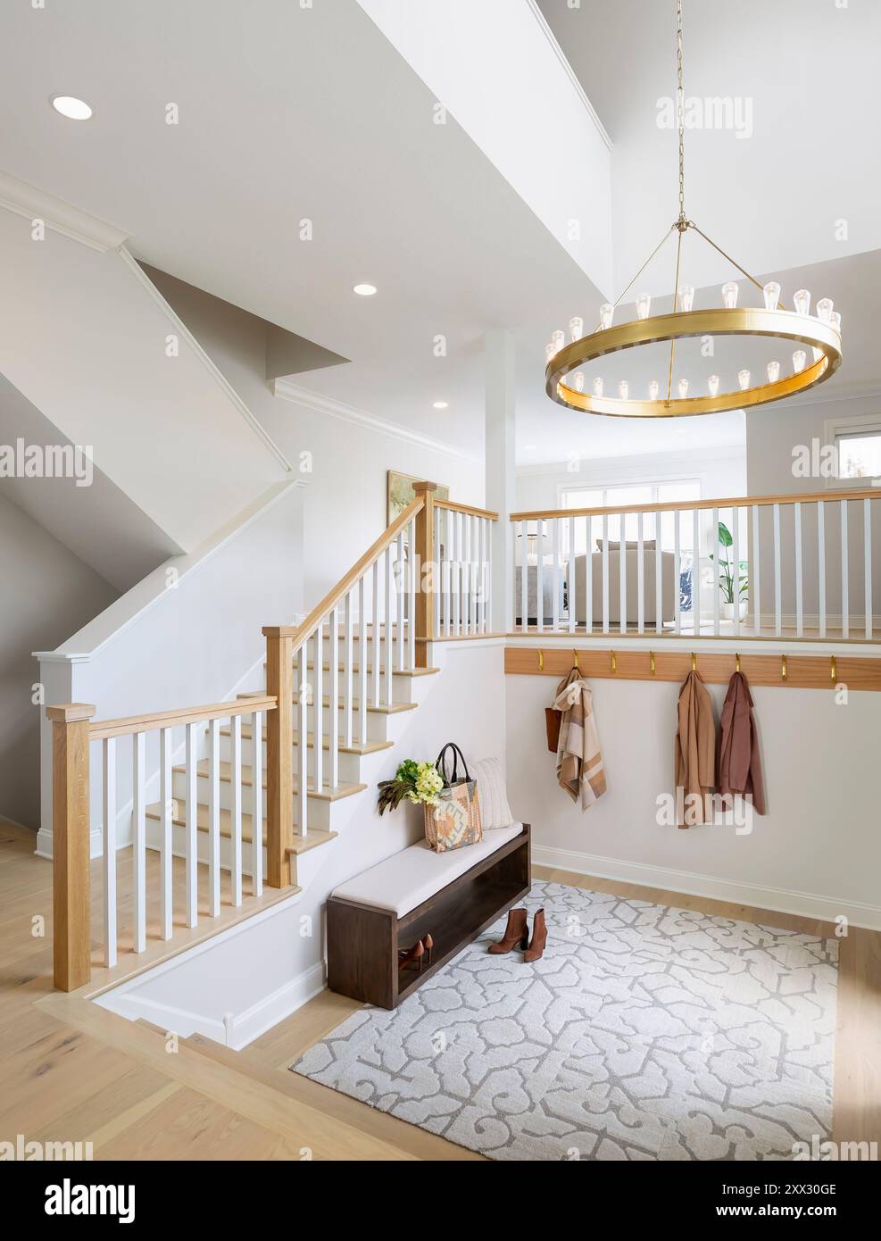 A large entryway with high ceiling and steps leading to a sitting area ...