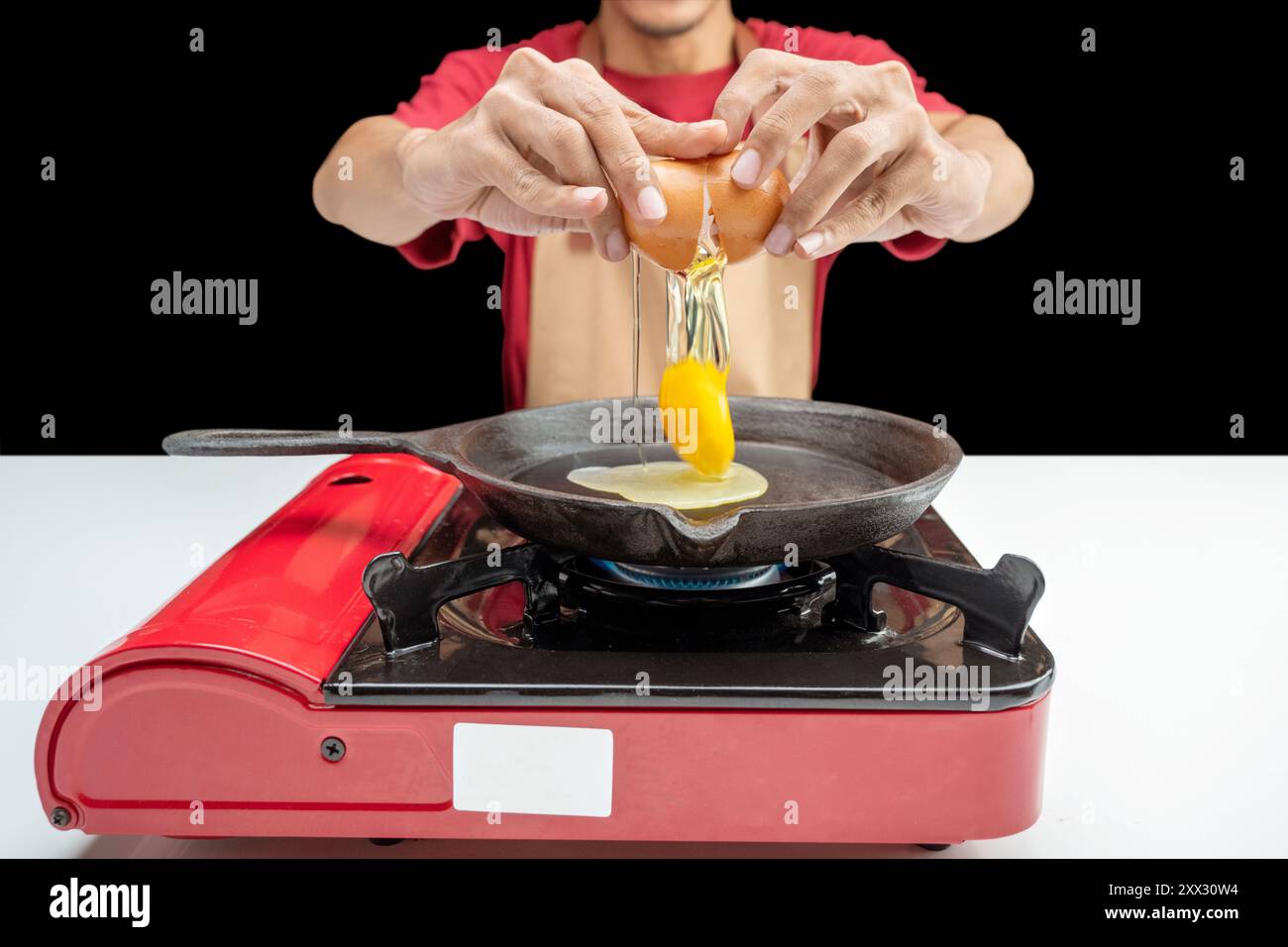 Chef cracking egg on frying hi-res stock photography and images - Alamy