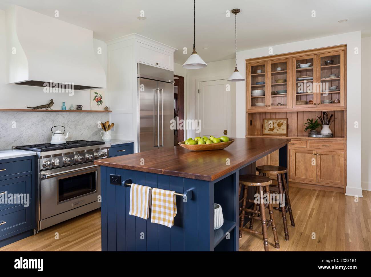 Kitchen with blue cabinets and built-in birch hutch Stock Photo - Alamy