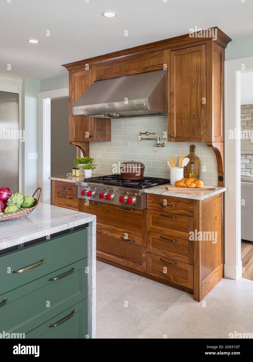 Walnut kitchen hutch surrounds Wolf cooktop with kitchen island in ...