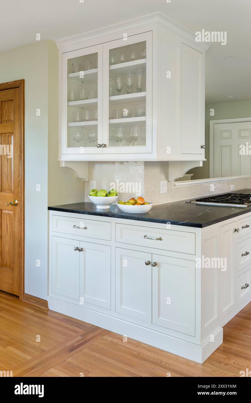 Corner cabinet in white kitchen showing glass cabinets with glassware ...