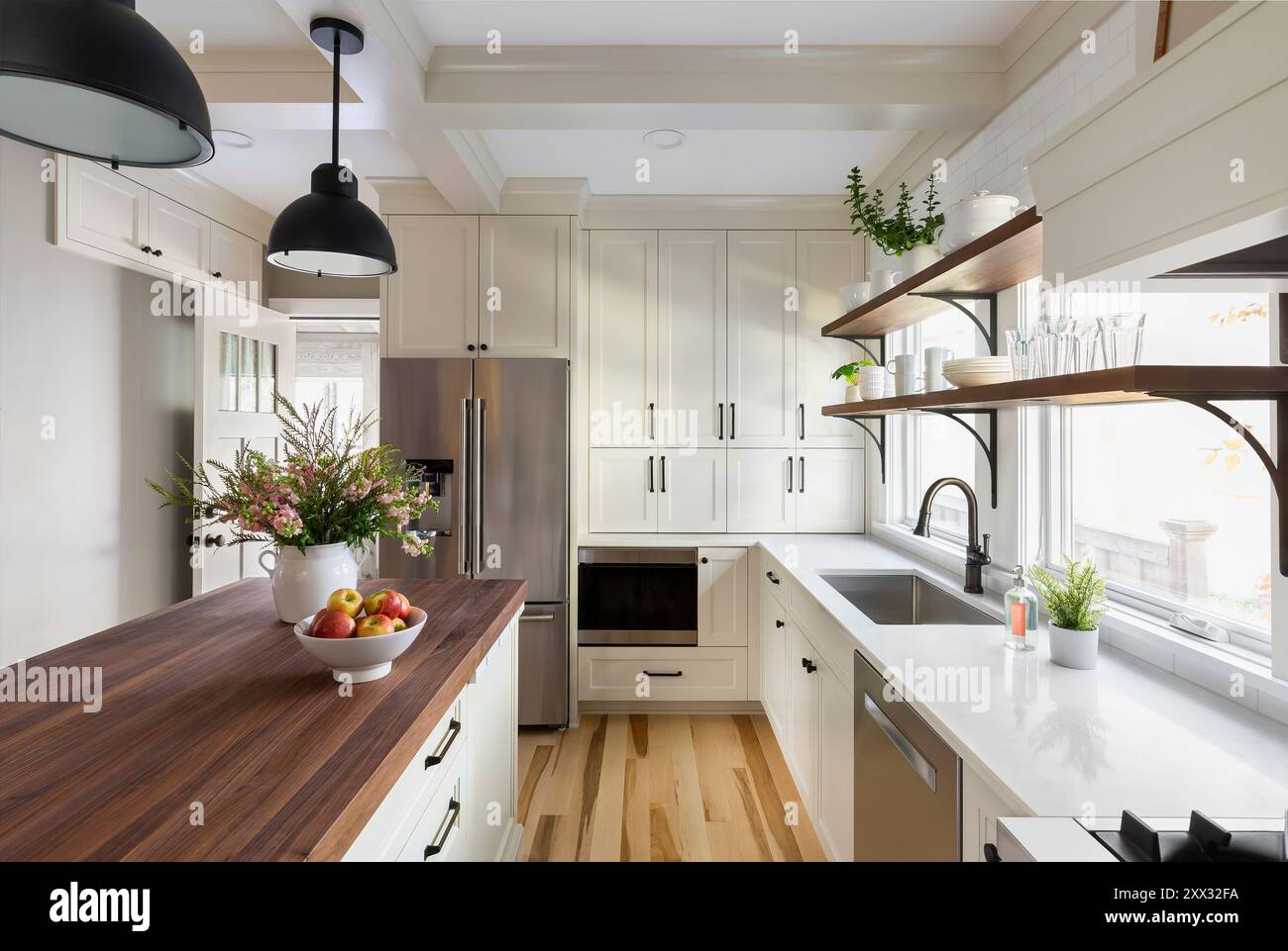 Kitchen with cream colored cabinets and walnut countertop and sh hi-res ...