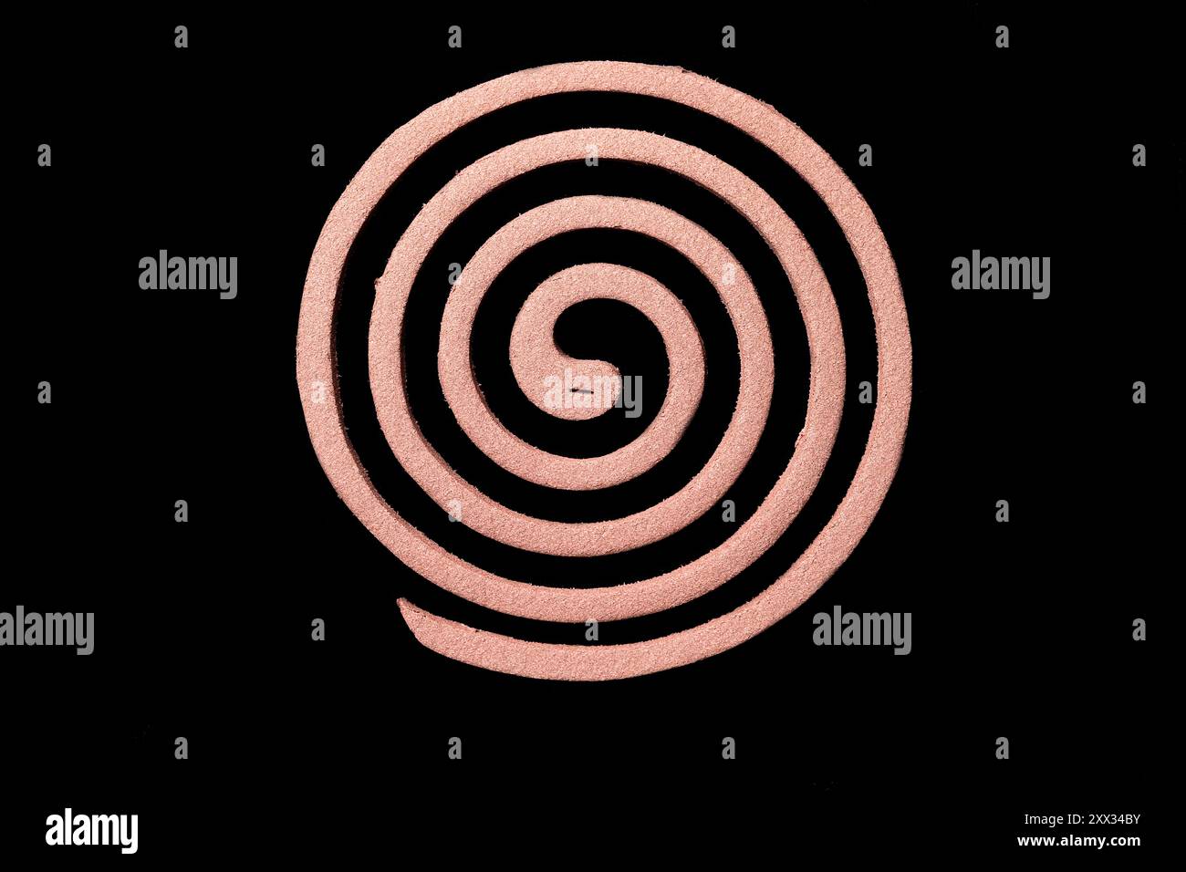Mosquito coils on black background. The spiral is very large and has a ...
