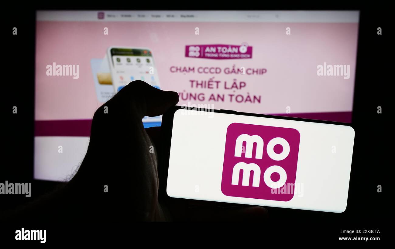 Person holding mobile phone with logo of Vietnamese fintech company ...