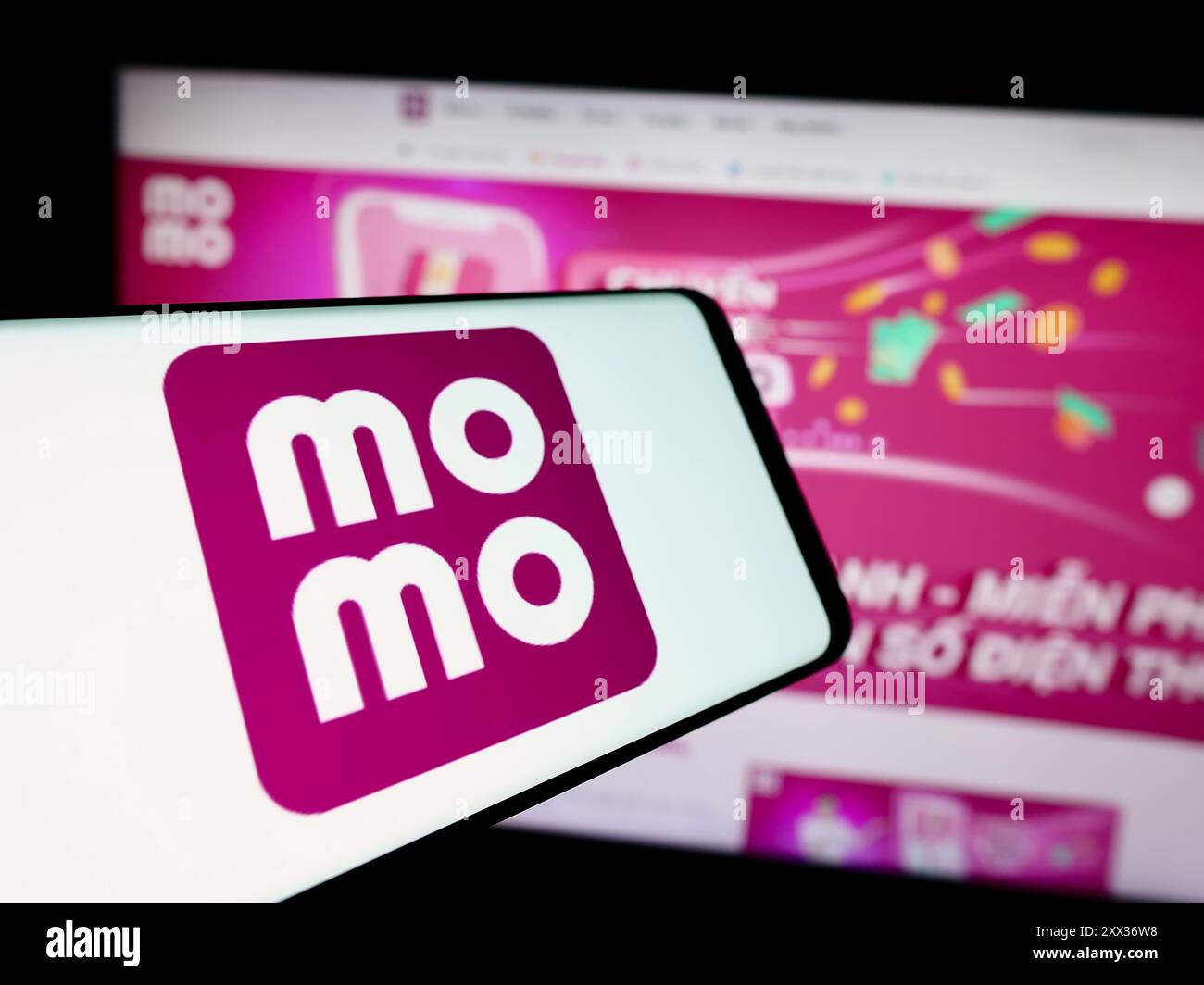Mobile phone with logo of Vietnamese fintech company MoMo in front of ...