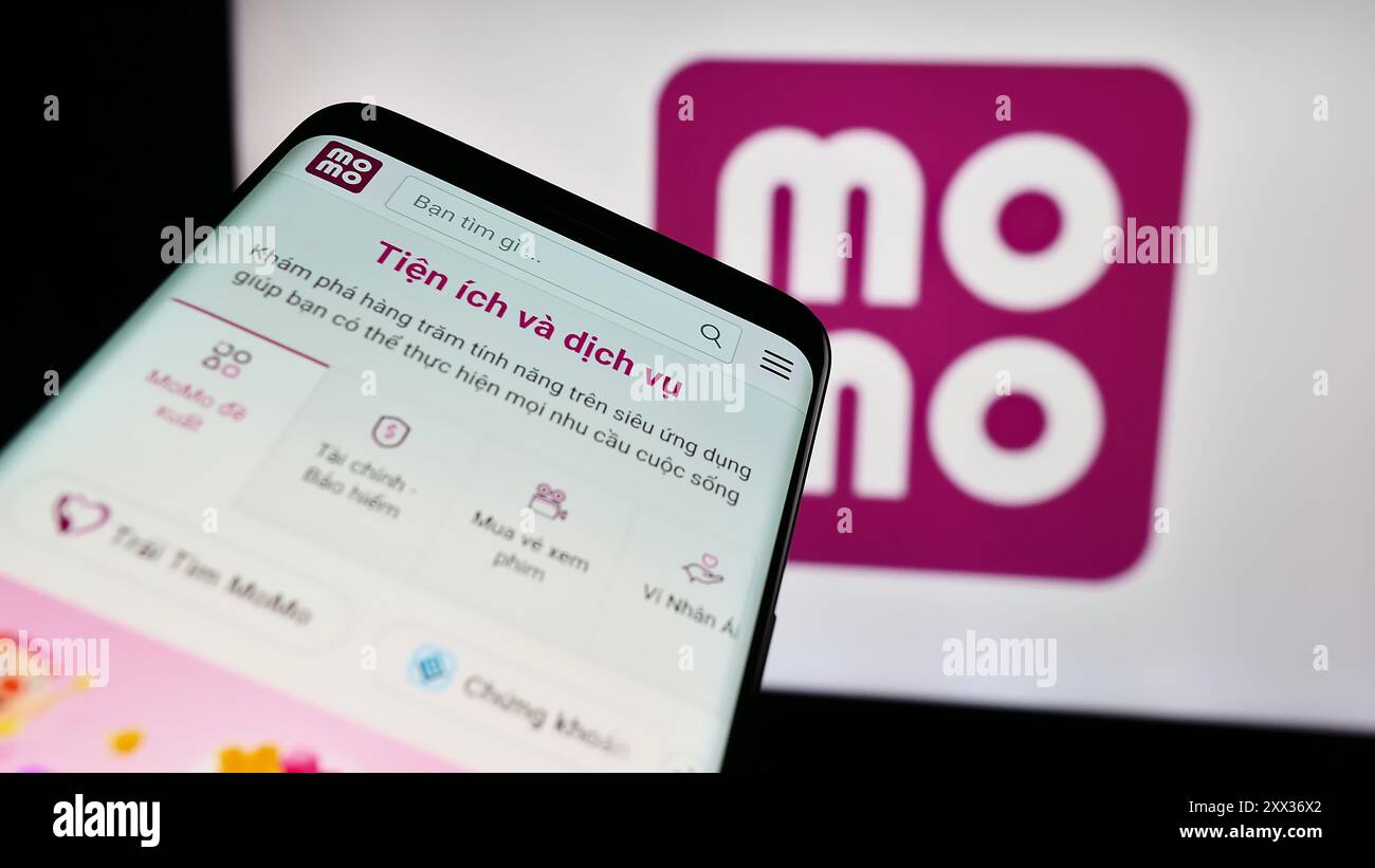 Smartphone with logo of Vietnamese fintech company MoMo in front of ...