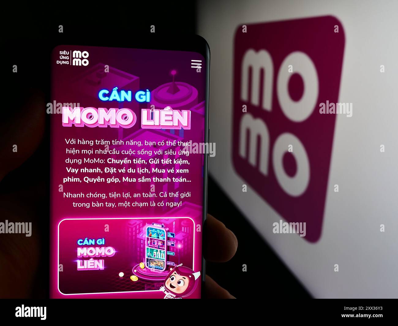 Person holding mobile phone with web page of Vietnamese fintech company ...